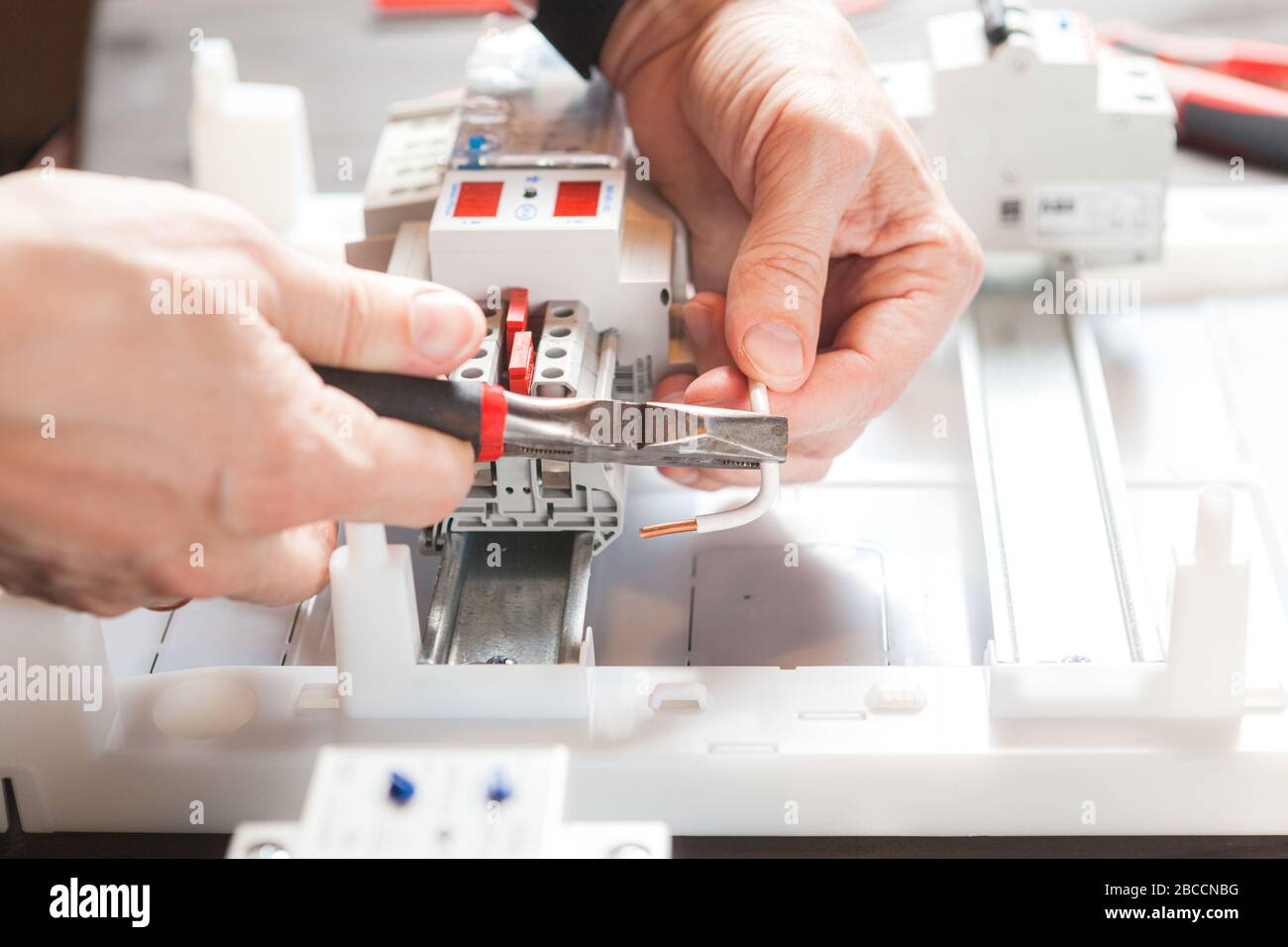 Men's hands close-up. Installation of an electric meter. Man cleaning ...