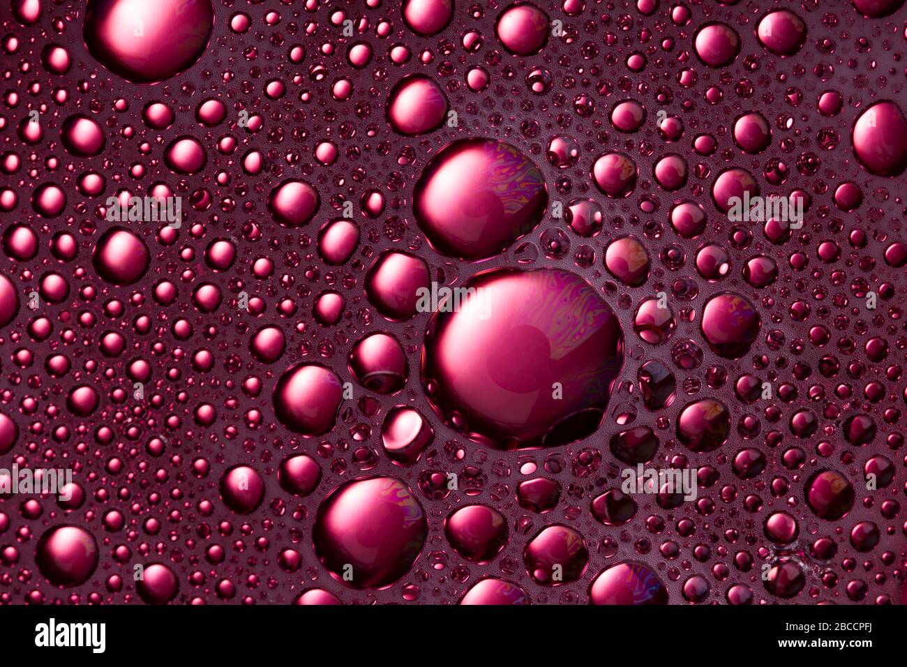 Purple bubbles of oil and water. Close up Stock Photo - Alamy