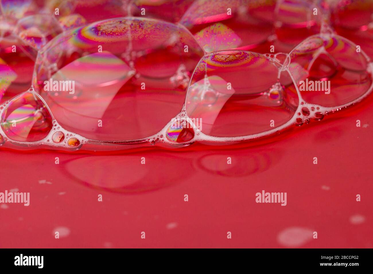 Red Background Of Suds Bubbles. Close up Stock Photo - Alamy