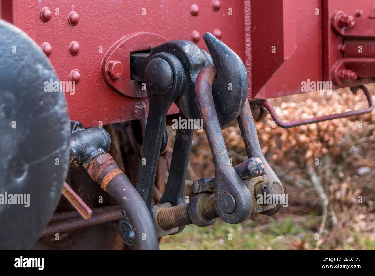 Old train carriage on rails, Red wooden train carriage. Old style hook ...