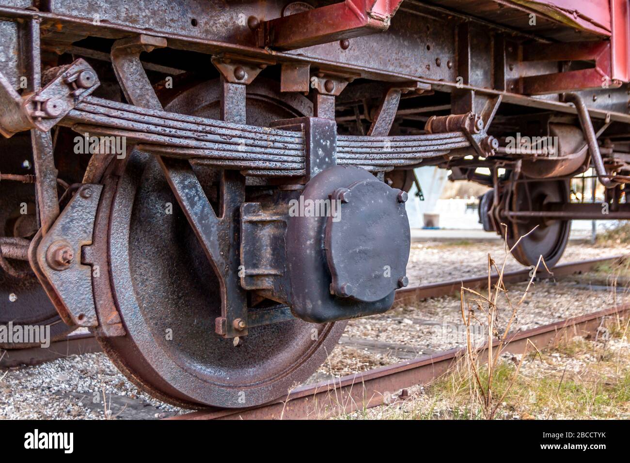 wheels on a vintage train wagon. old red vintage train wagon. stands on ...