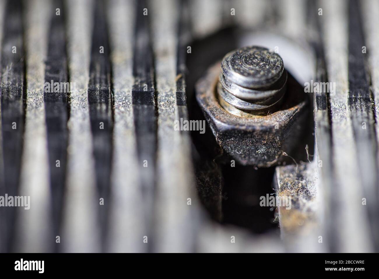 Close up view of bolt and nut with dirty stain with vertical lines ...