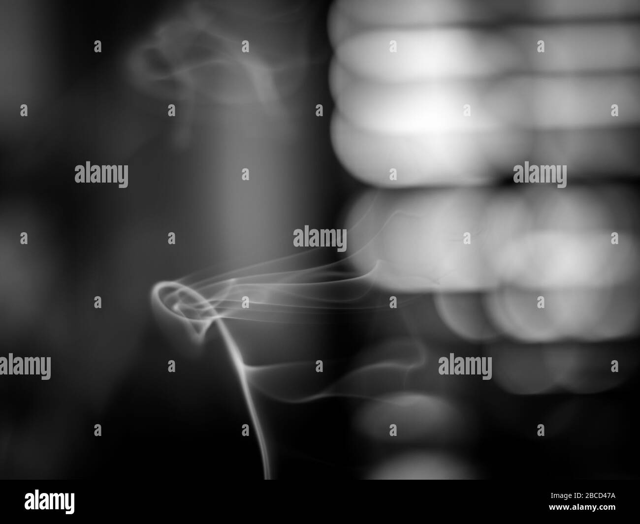 Artistic and relaxing isolated close up incense smoke movement indoors ...
