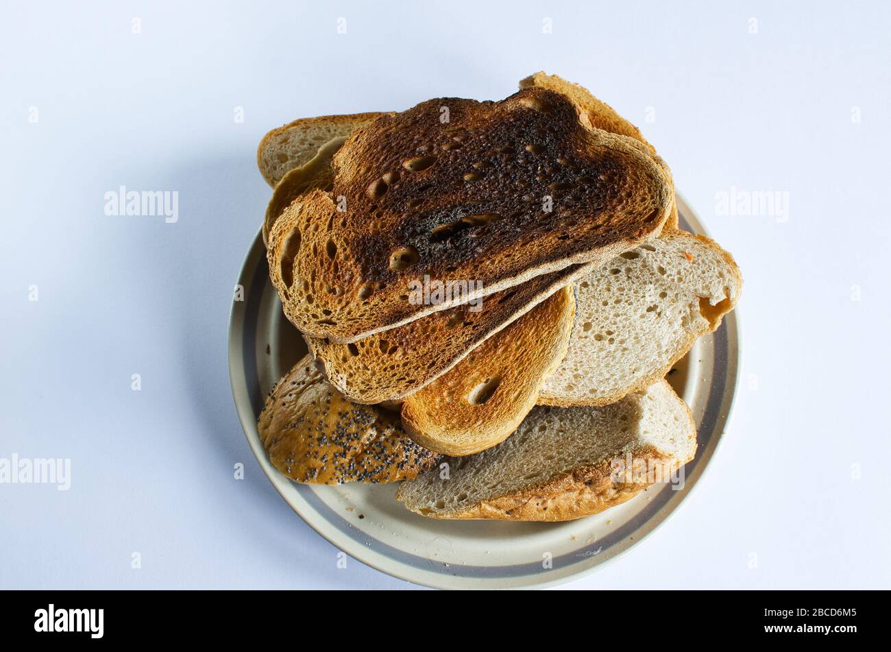 Burnt toasts and old pieces bread isolated on white background Stock ...