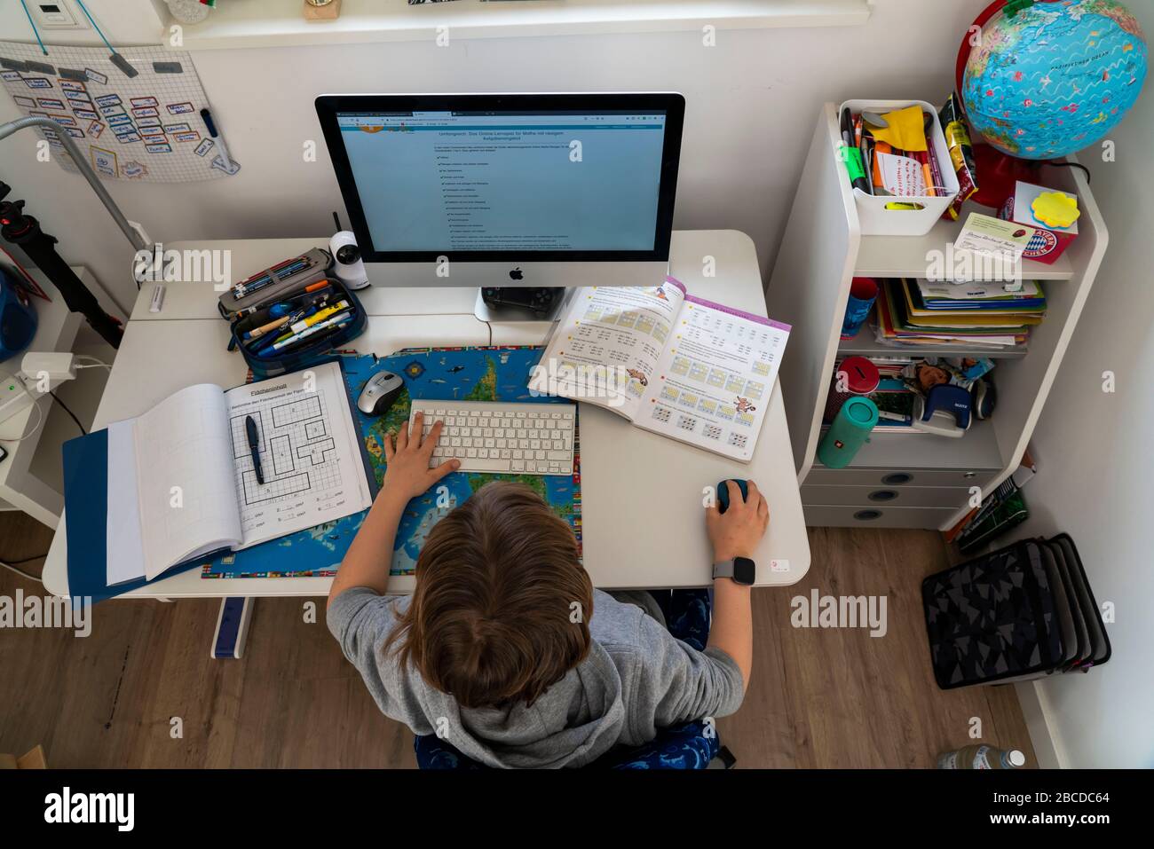 Young boy, primary school children, home learning, doing schoolwork ...