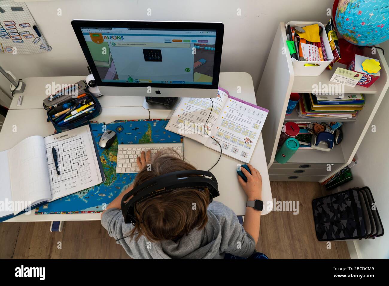 Boy, primary school children, home learning, doing homework, distance ...