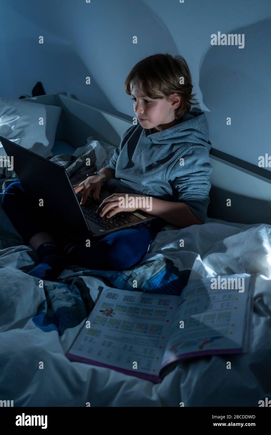 Boy, at home on the computer, laptop, in the kids' room, playing a game ...