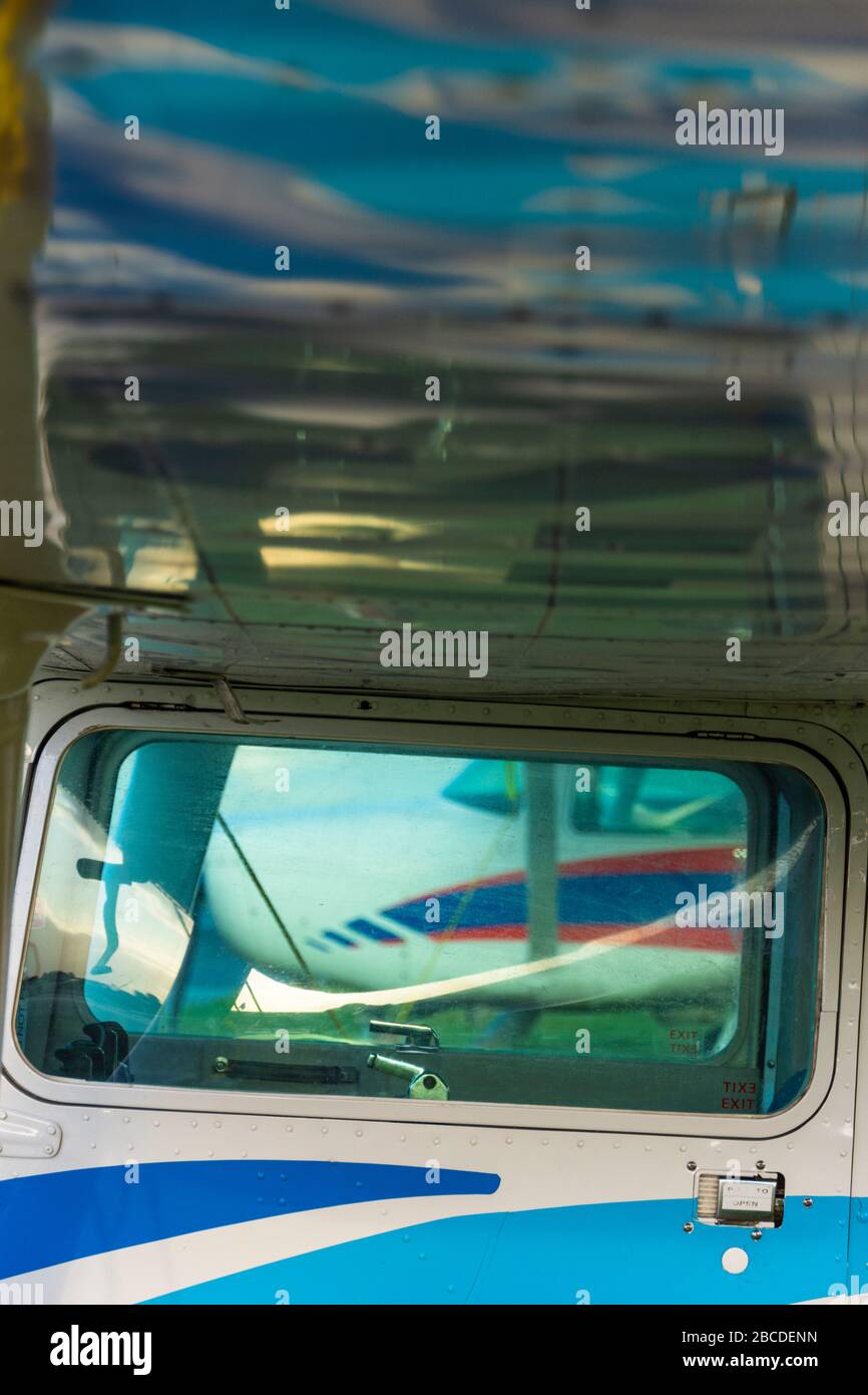 Abstract view under the wing of a Cessna light aircraft looking through ...