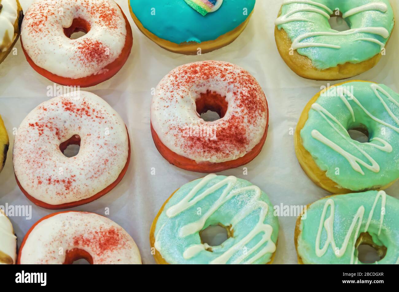Very much delicious multi-colored donuts coated with sweet glaze Stock ...