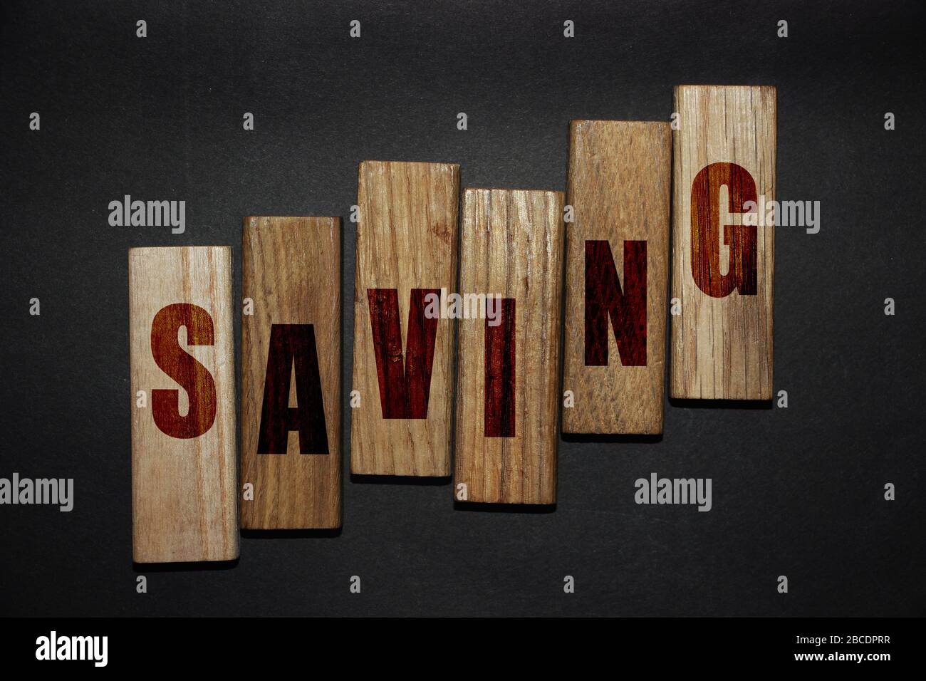 Saving word letters written on wooden blocks reminding diagram going up ...