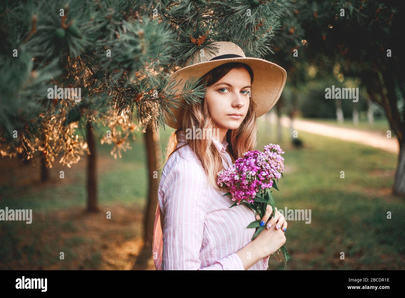 Portrait of a beautiful girl looking into the distance at the Park at ...