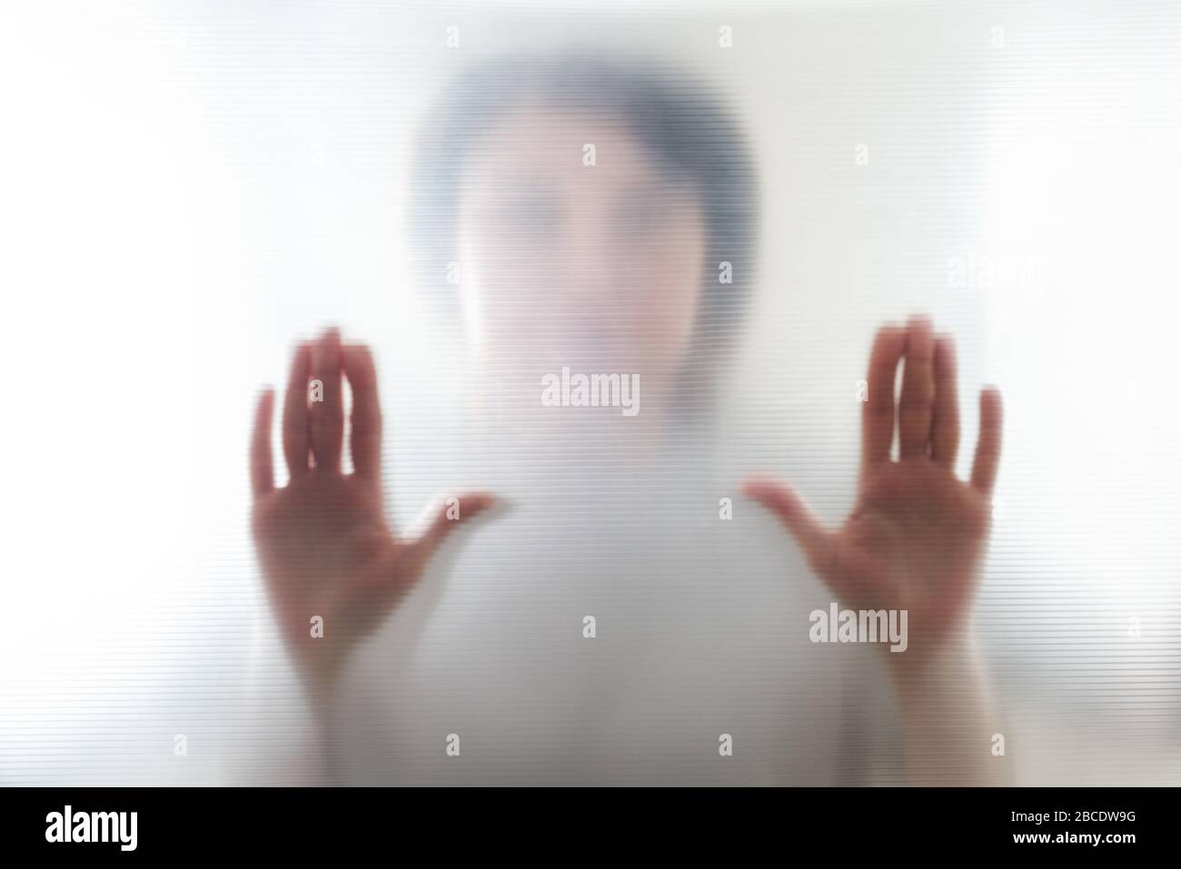 Silhouette hand against frosted glass hi-res stock photography and ...