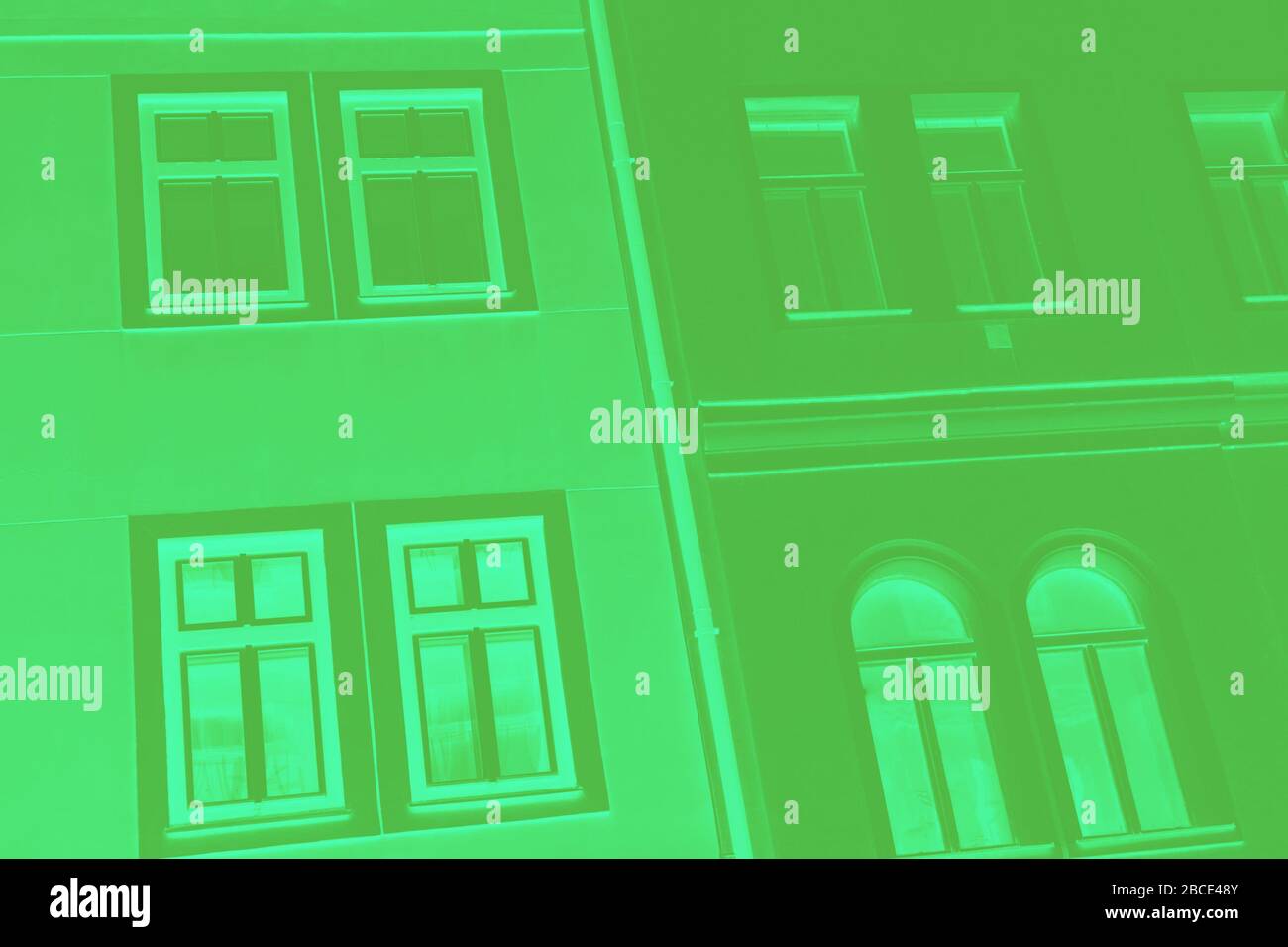 Green wall with windows. Fragment, details. Shades of green, toned ...