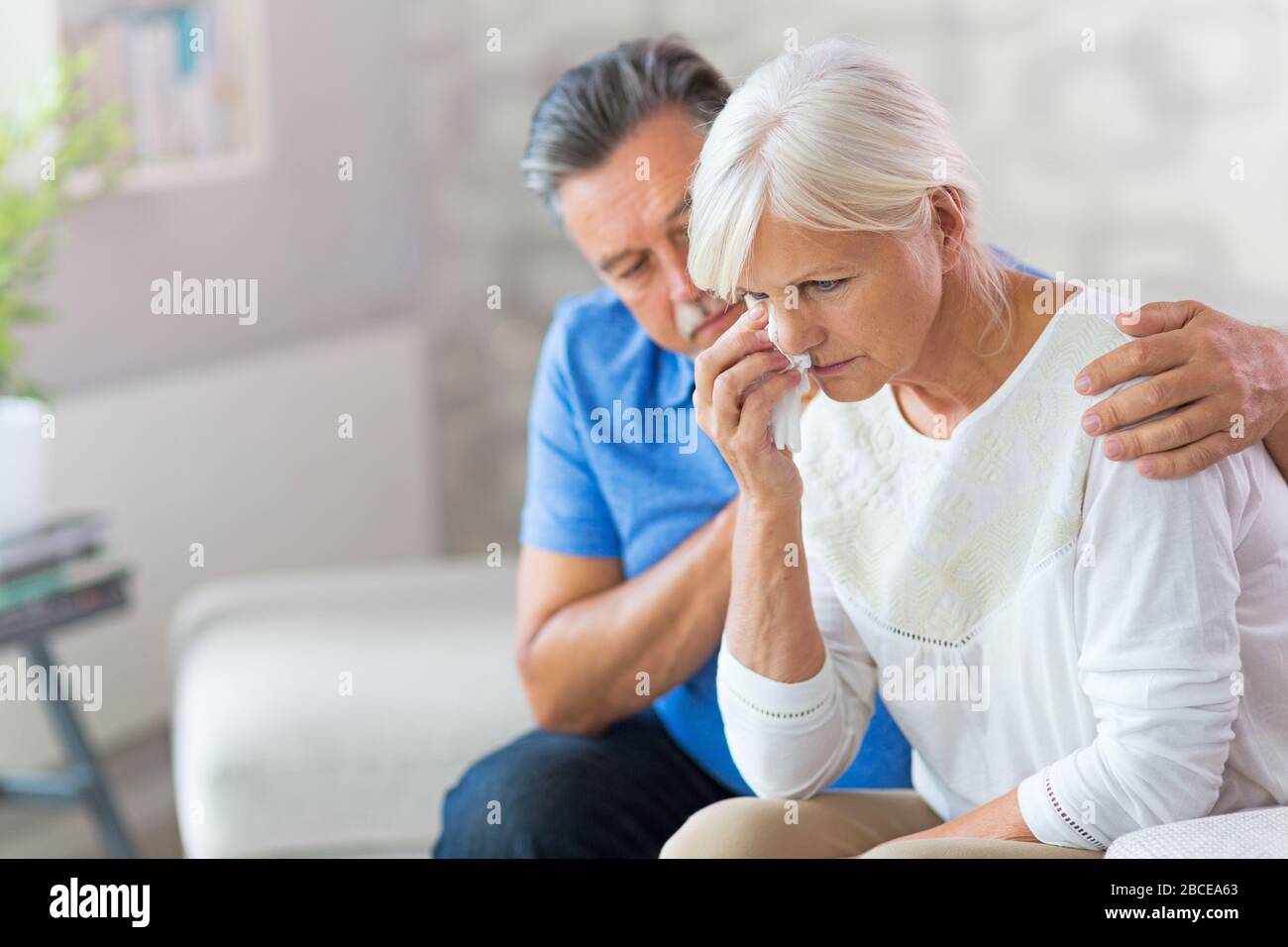 Senior Man Consoling Wife Stock Photo - Alamy