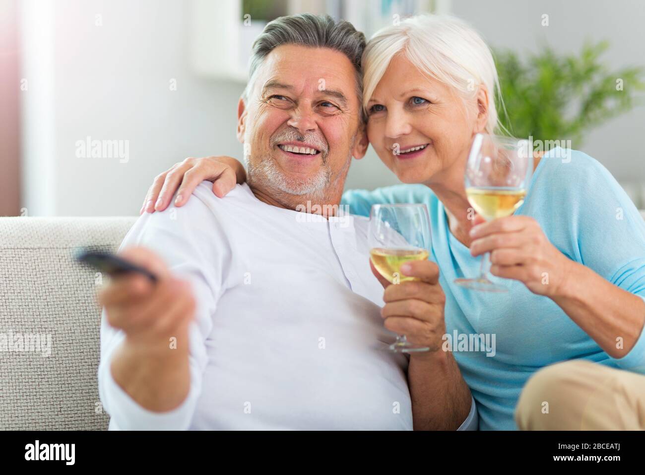 Senior couple with remote control Stock Photo - Alamy