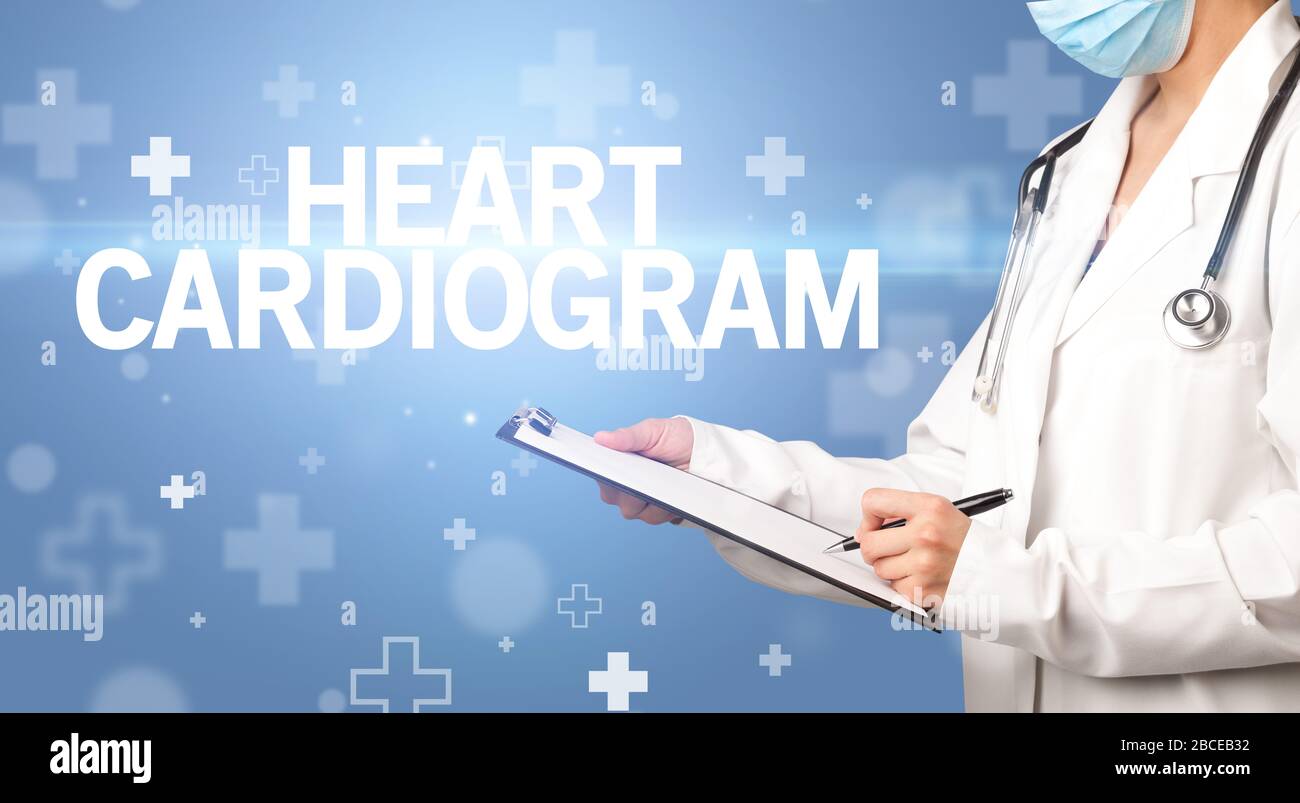 doctor writes notes on the clipboard with HEART CARDIOGRAM inscription ...