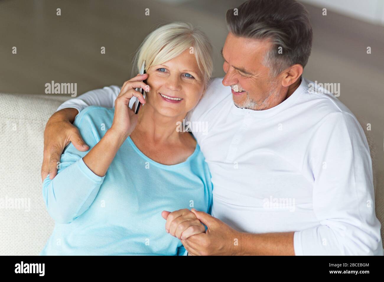 Senior couple using mobile phone Stock Photo - Alamy