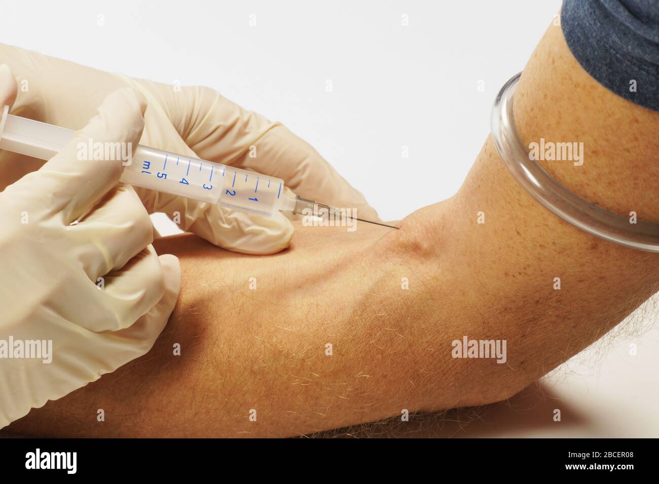 Hands of nurses wearing gloves during the injection. Intravenous ...