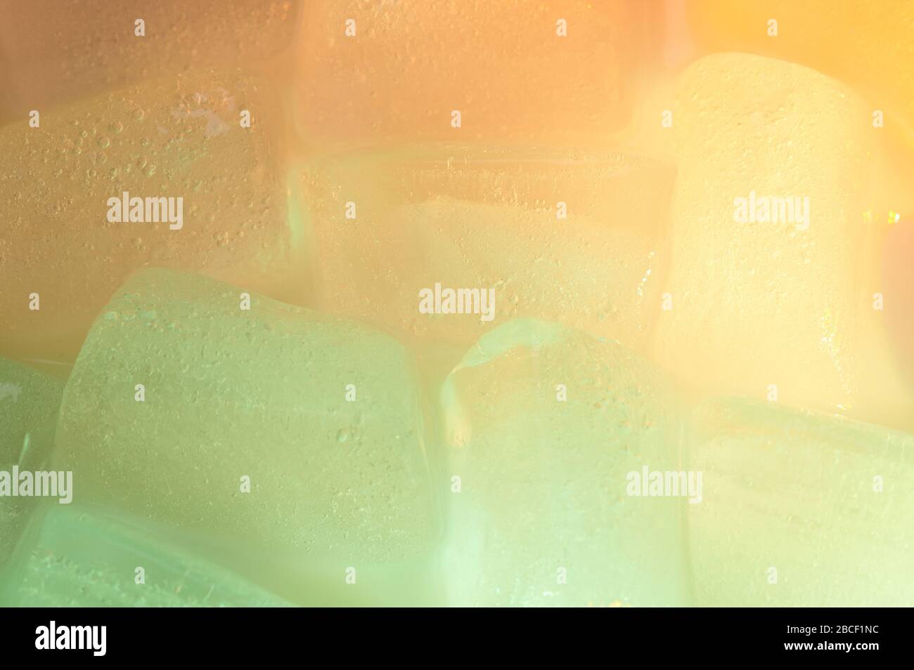 Colorful clean ice background. Green anf orange color ice cubes pattern ...