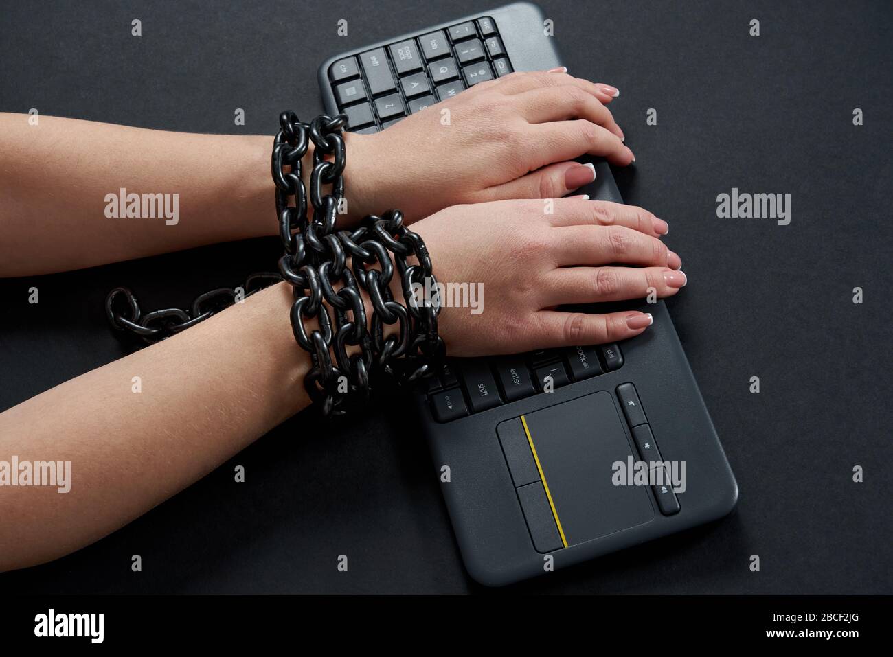Female hands Chained to Keyboard, addiction concept Stock Photo - Alamy