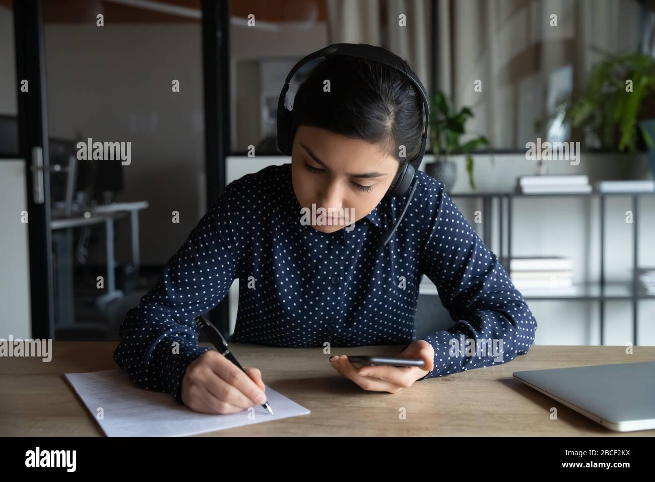 Young indian woman listening audio lecture in mobile application Stock ...