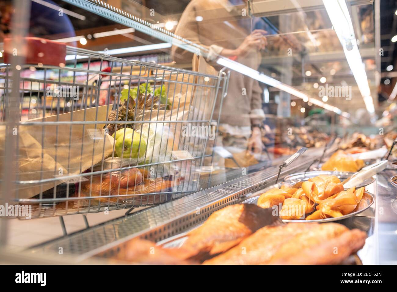 Smoked fish and other seafood gastronomy on large long display in ...