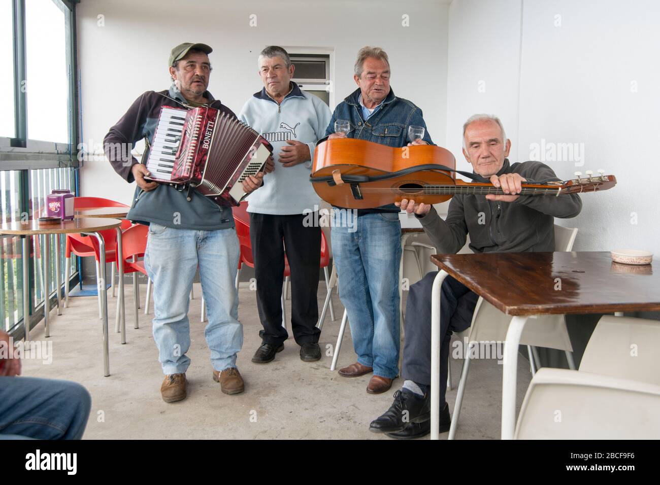 older men are singing Fado at a smal cafe bar im Monte near the city ...