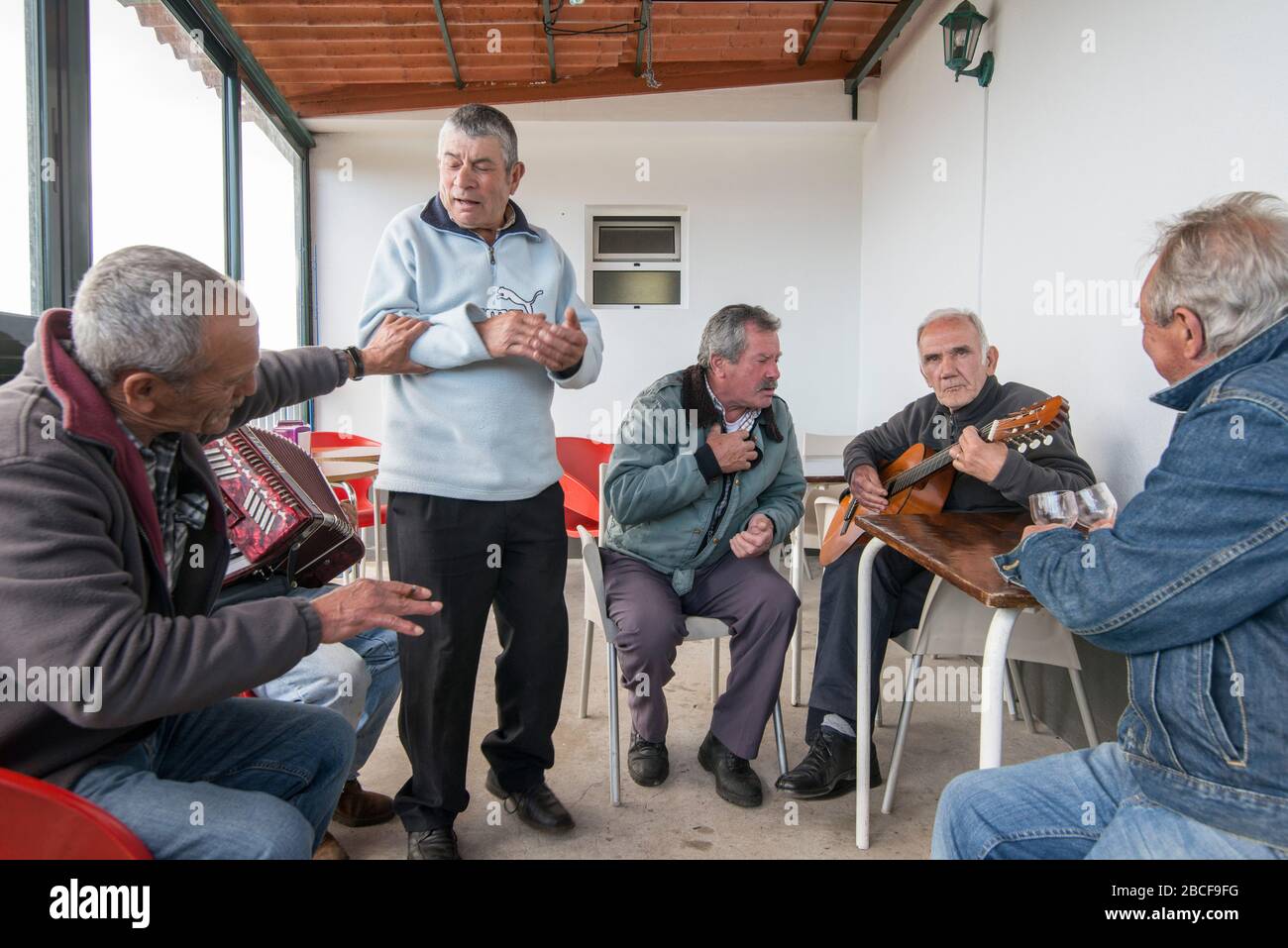 older men are singing Fado at a smal cafe bar im Monte near the city ...