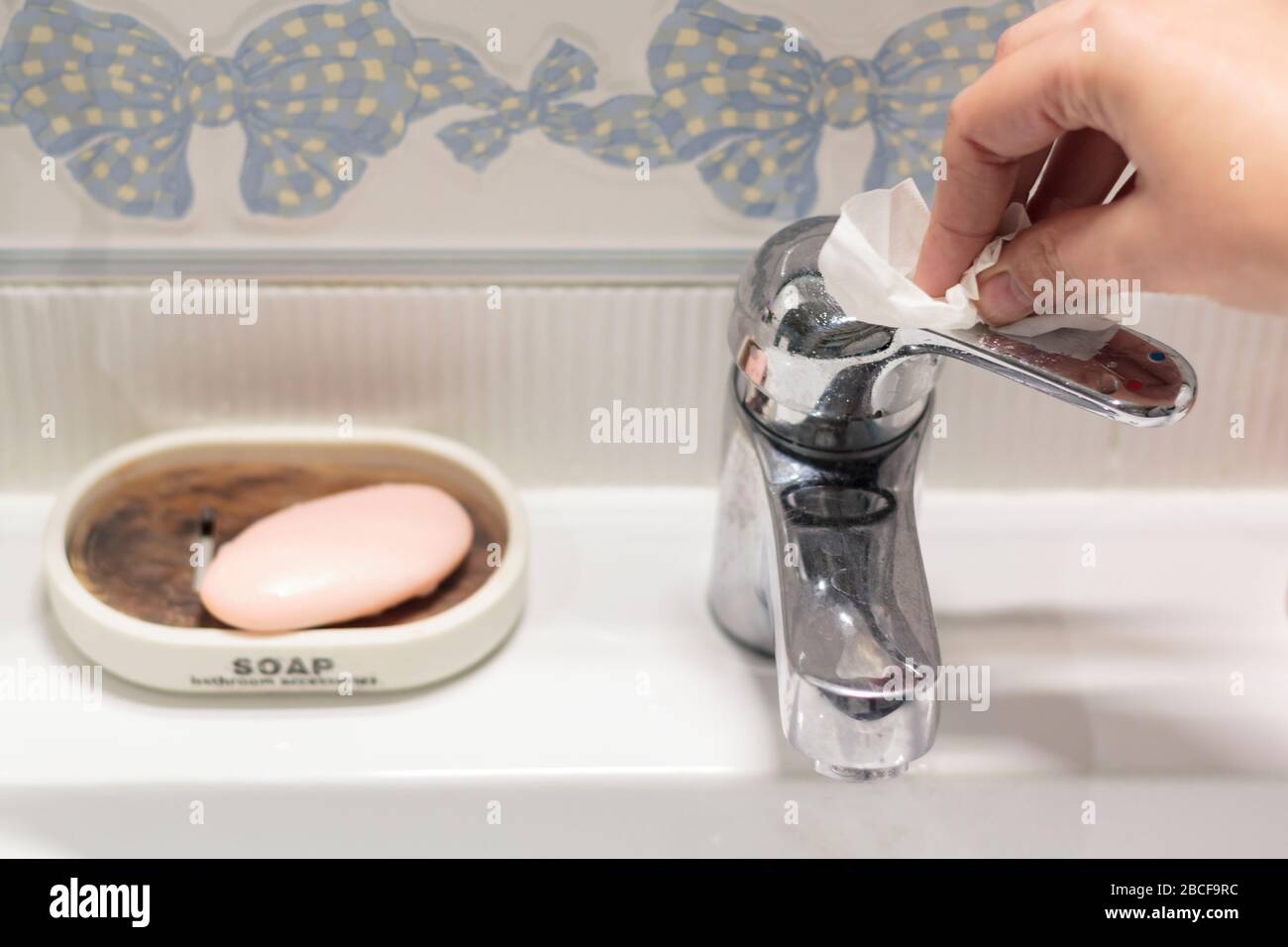 Clean and disinfect bathroom faucet. Germs, bacteria, Covid-19 ...