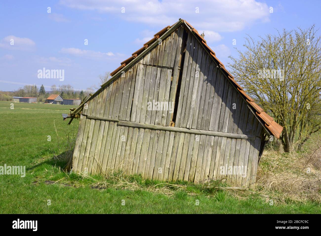 old broken hut partly sunk into the wet soil, wetland hut in bad state ...
