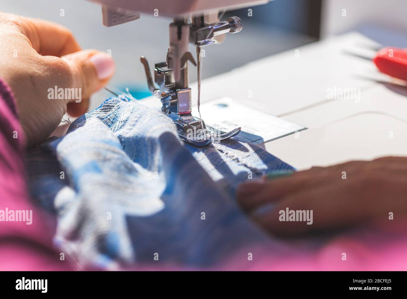 Close up of sewer working with textile and sewing needle Stock Photo ...