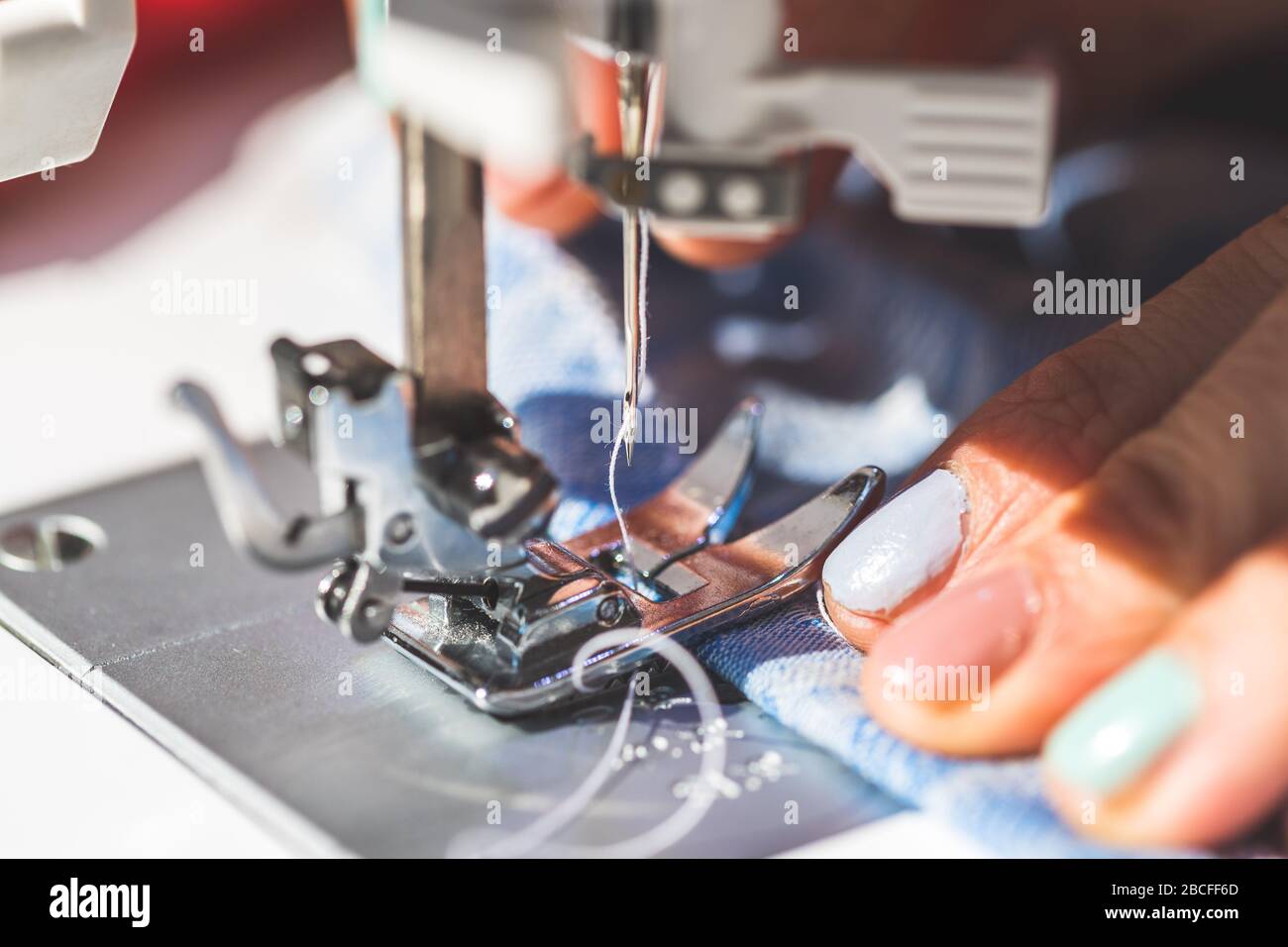 Close up of sewer working with textile and sewing needle Stock Photo ...