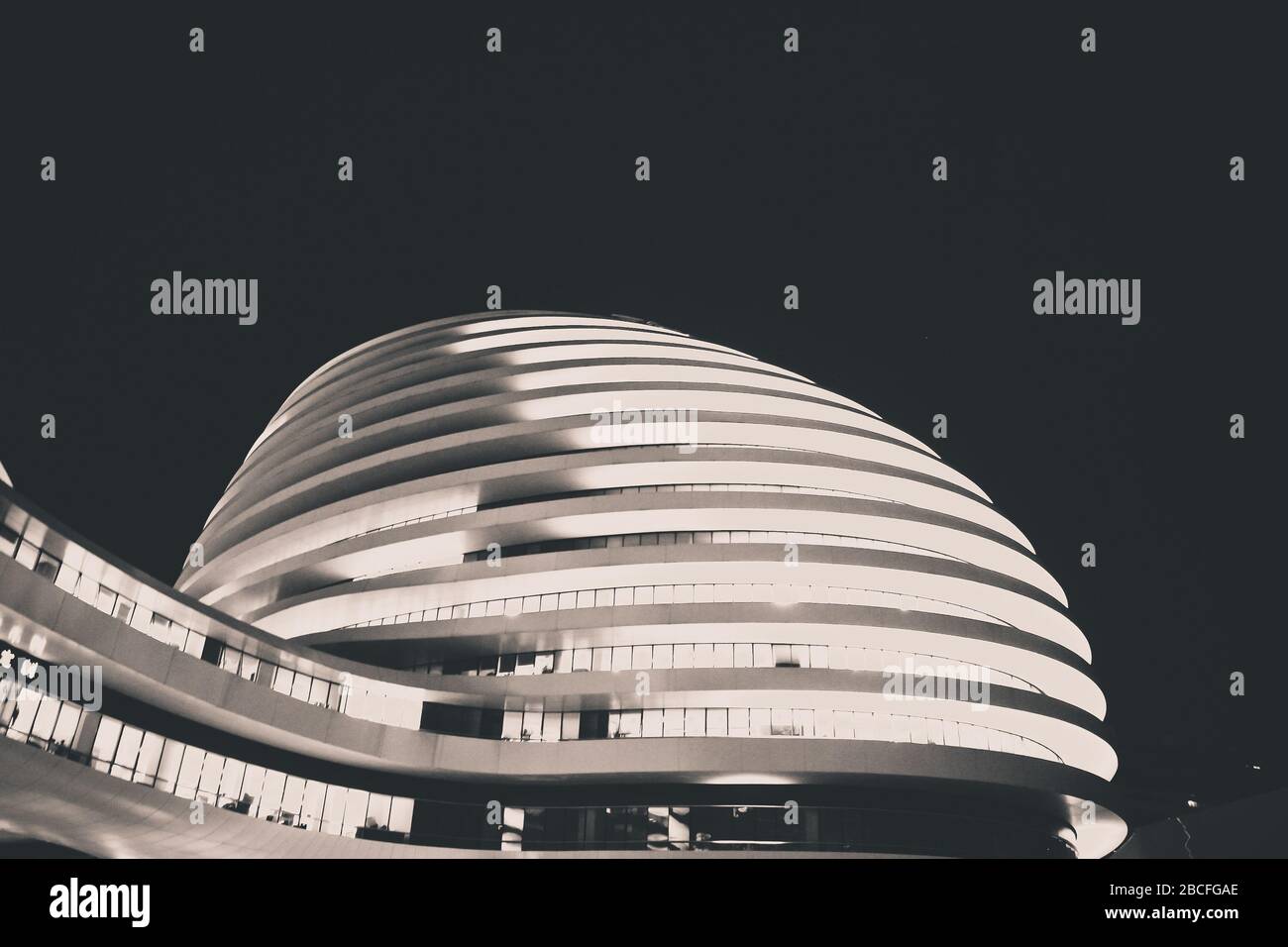 curve building at night in black and white Stock Photo - Alamy