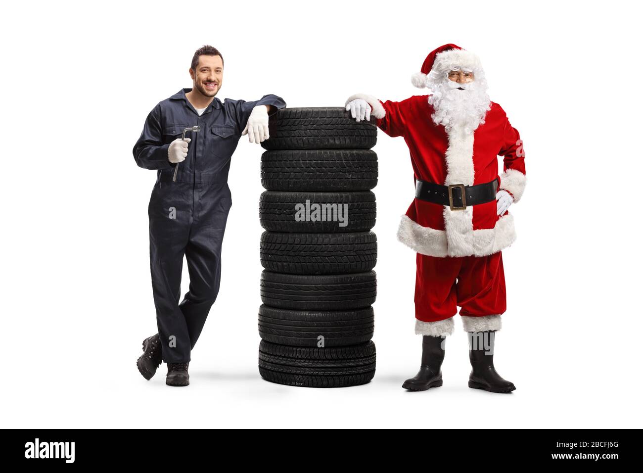 Auto mechanic holding a wrench and Santa Claus posing with a pile of ...