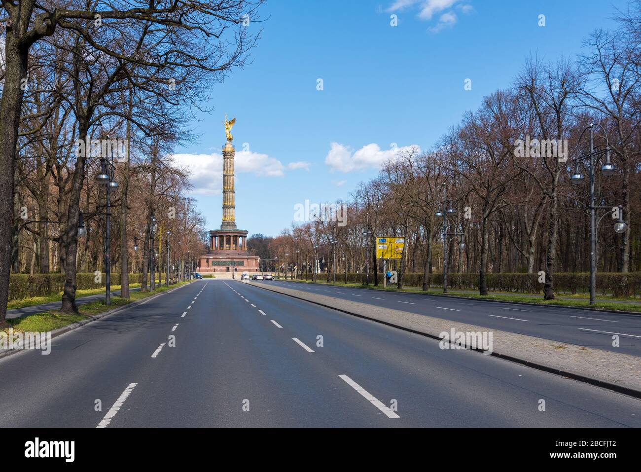 Deserted street in Tiergarten park with Siegessaeule Victory Column in ...