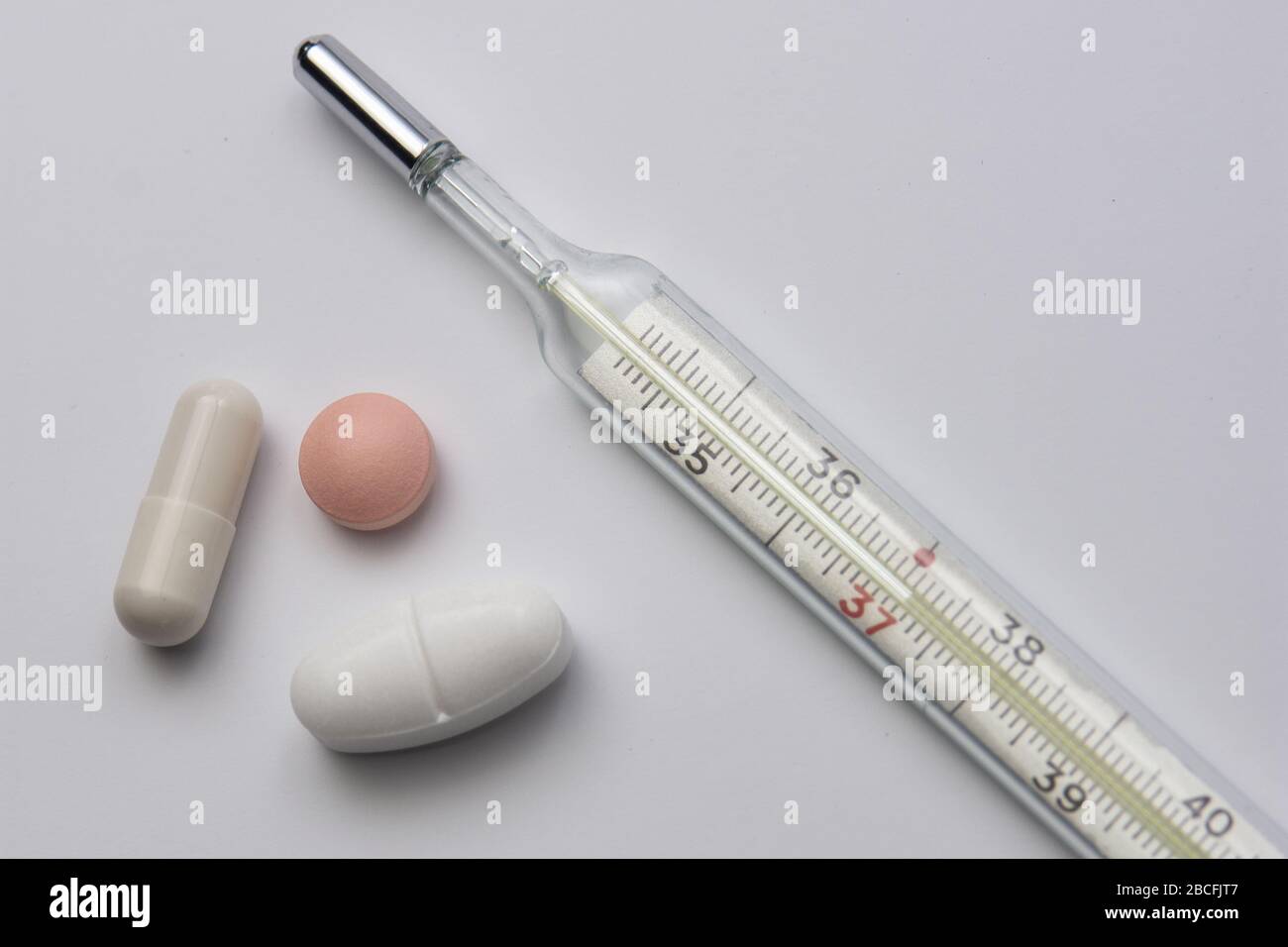 pill packs, industial thermometer with colorful medicaments lying on ...