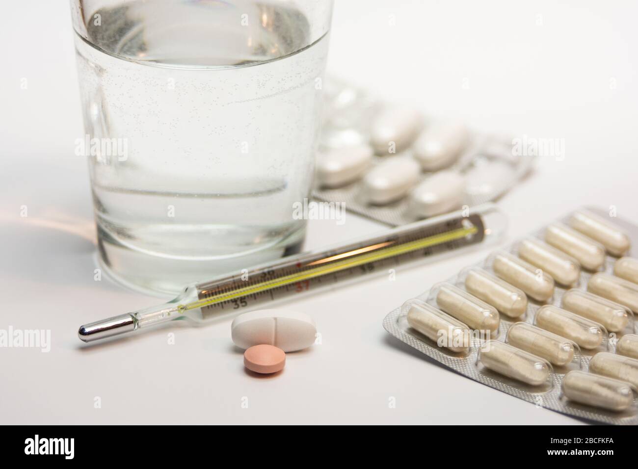pill packs, industial thermometer with colorful medicaments lying on ...