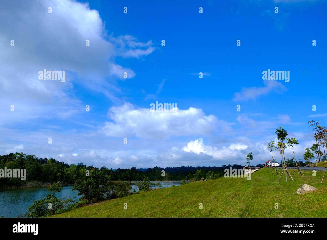 green field with lake and sky background Stock Photo - Alamy
