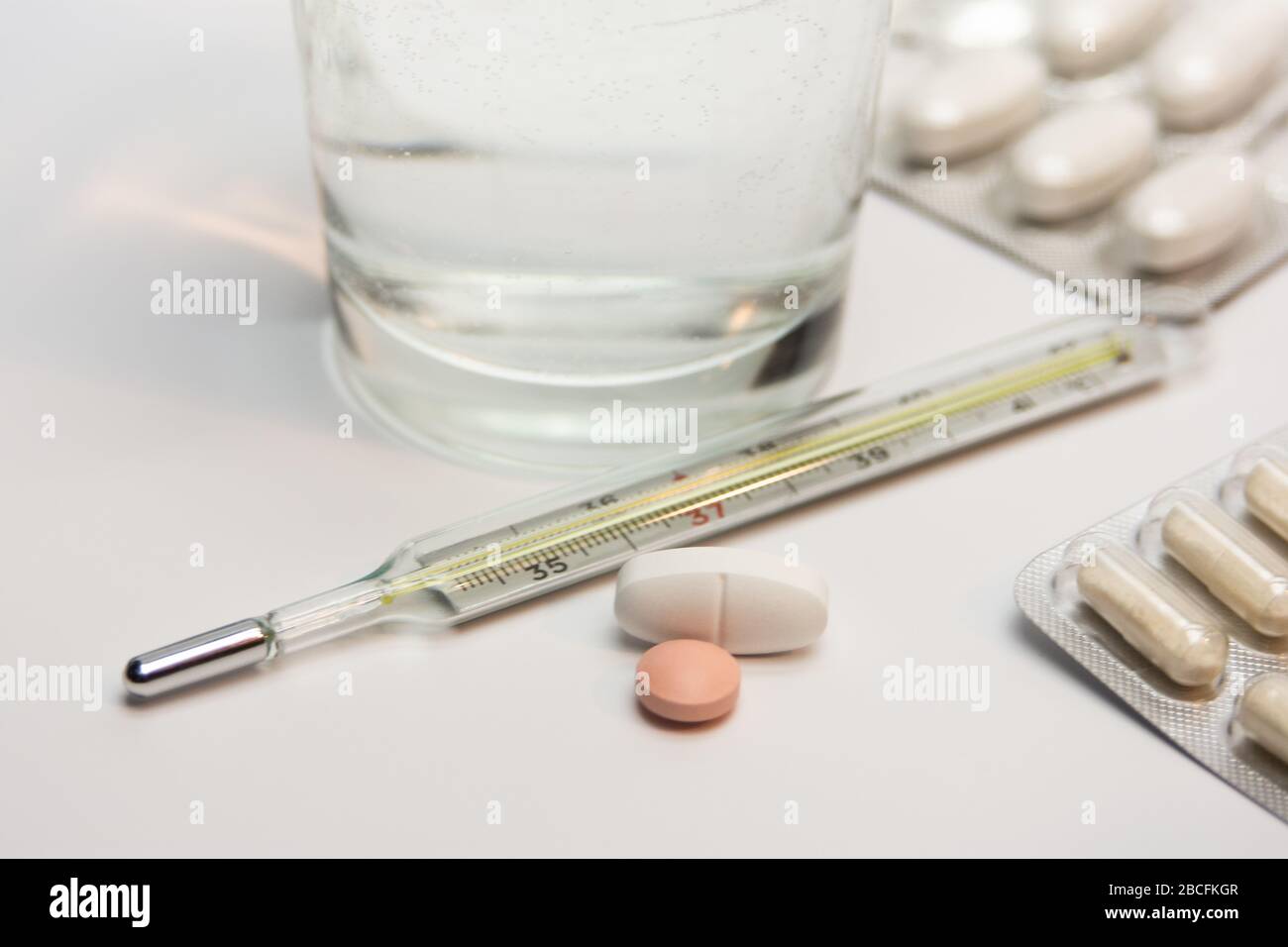 pill packs, industial thermometer with colorful medicaments lying on ...
