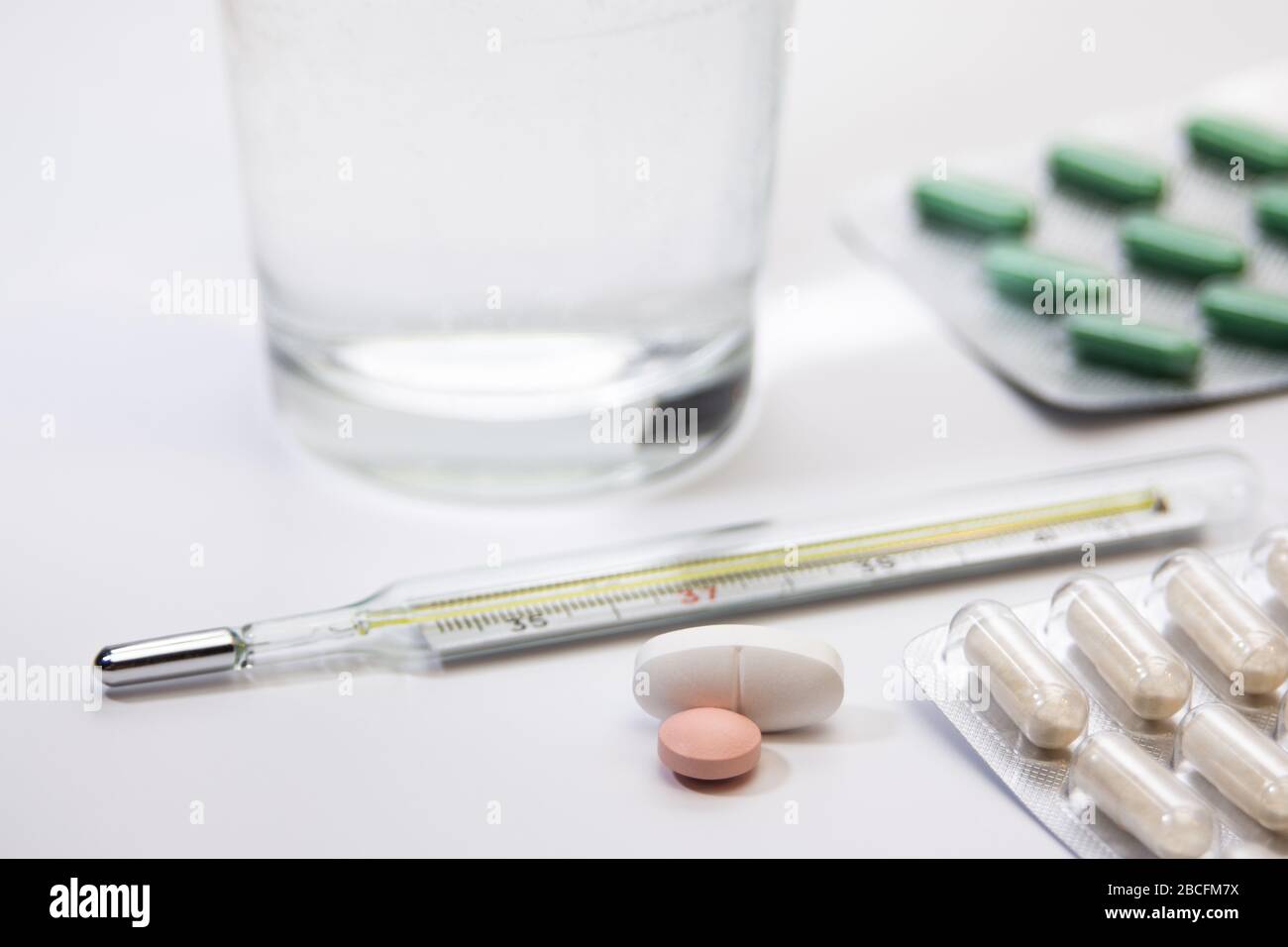 pill packs, industial thermometer with colorful medicaments lying on ...
