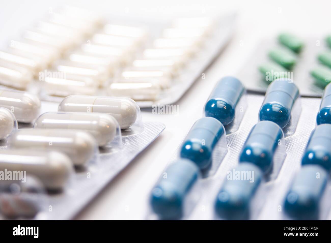 pill packs with colorful medicaments lying on the white background ...