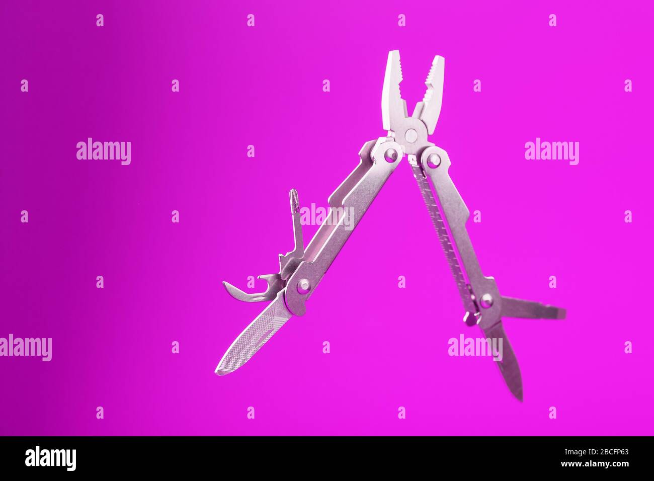 Multitool is a multi-functional tool on a pink background. The concept ...