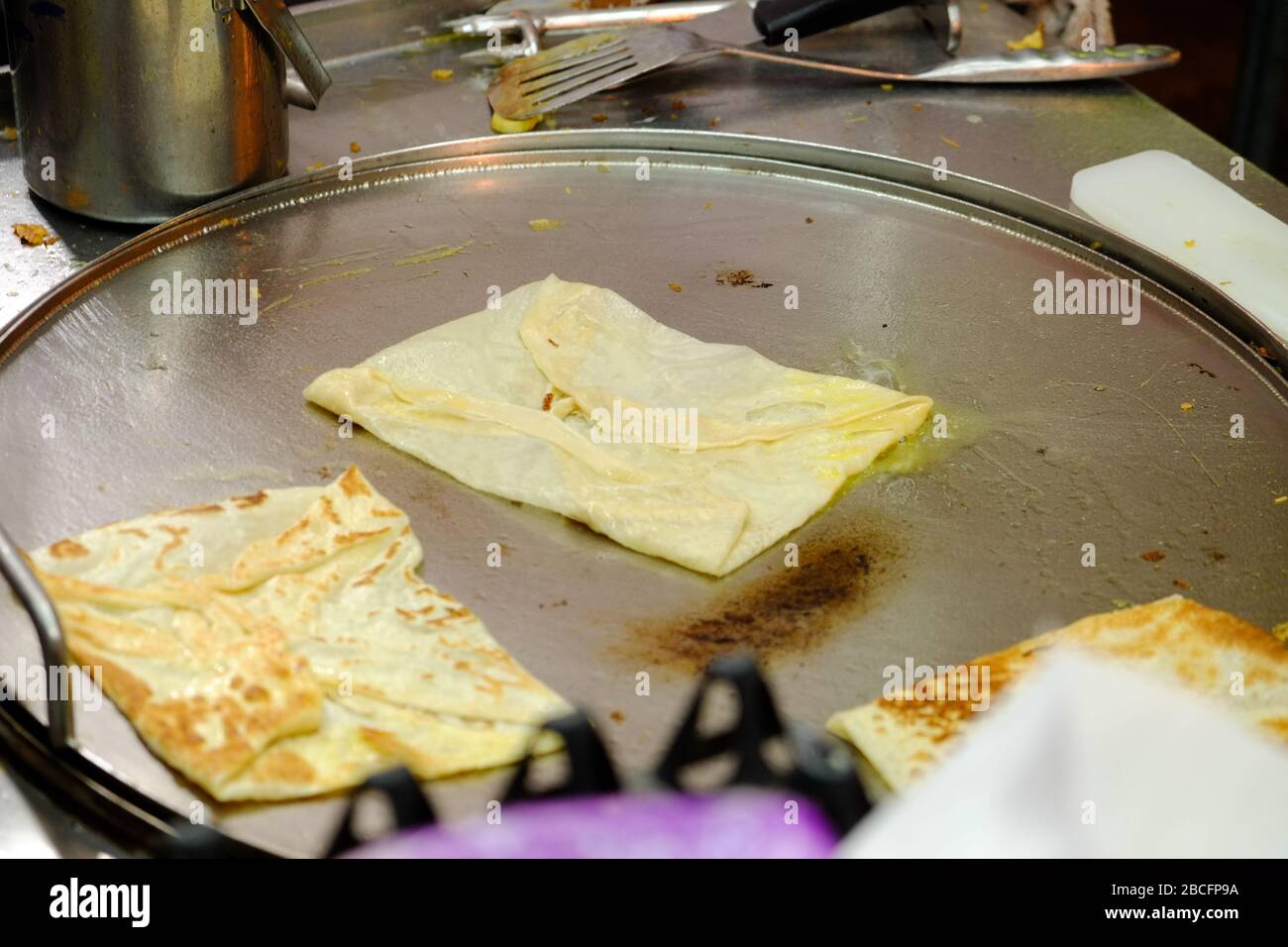 roti frying on the big pan Stock Photo - Alamy