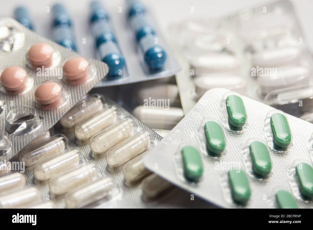 pill packs with colorful medicaments lying on the white background ...