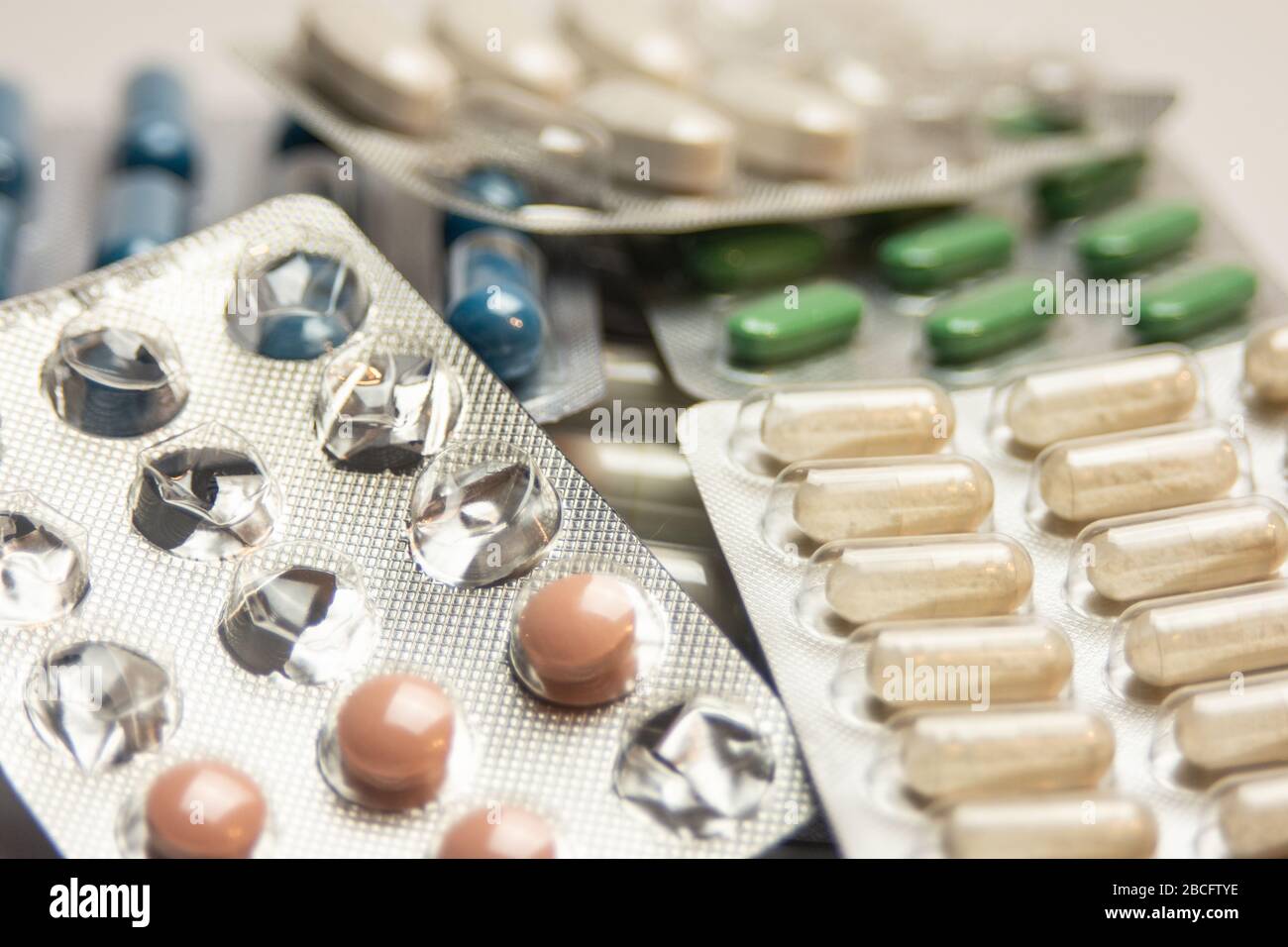 pill packs with colorful medicaments lying on the white background ...