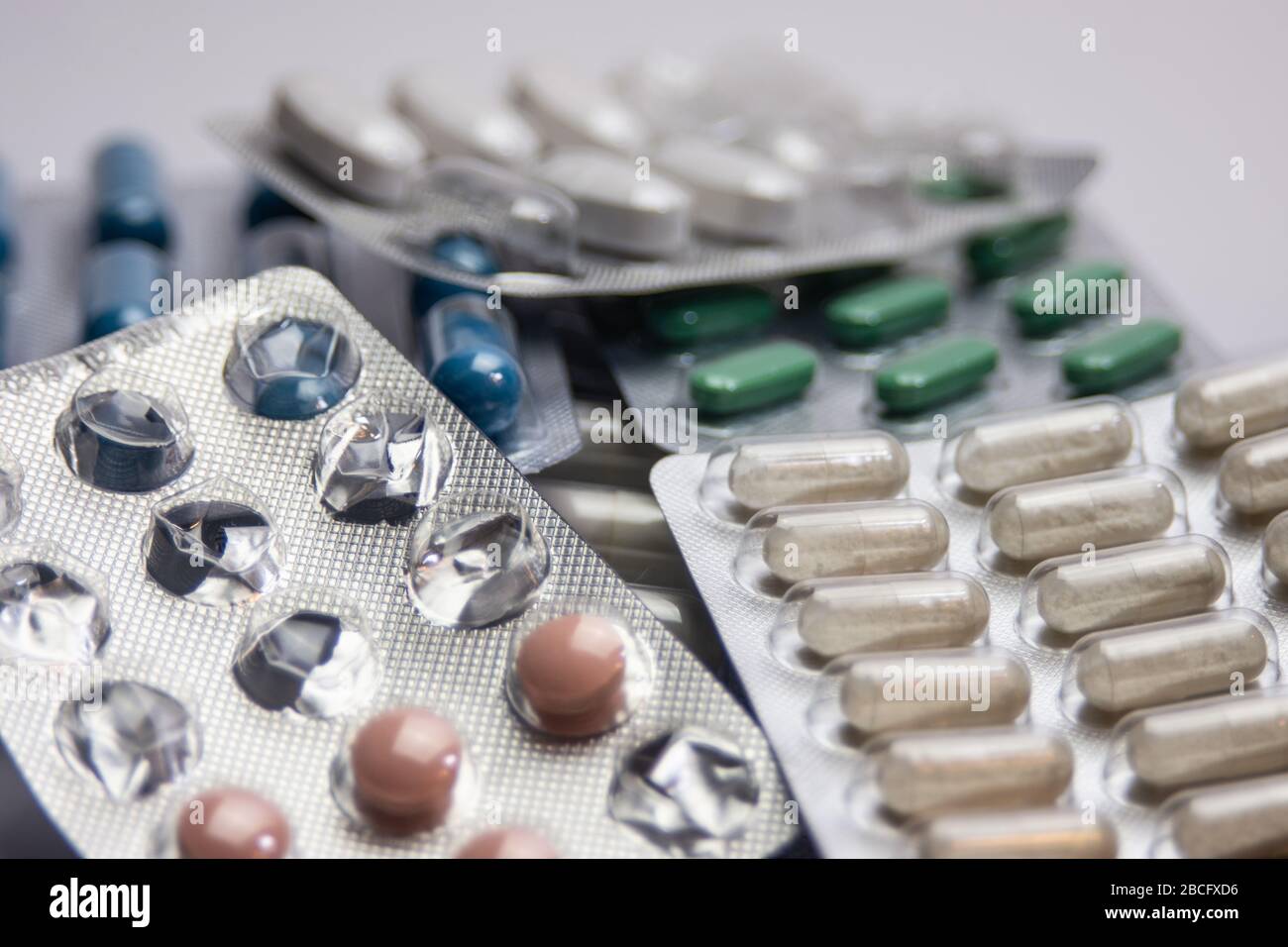 pill packs with colorful medicaments lying on the white background ...