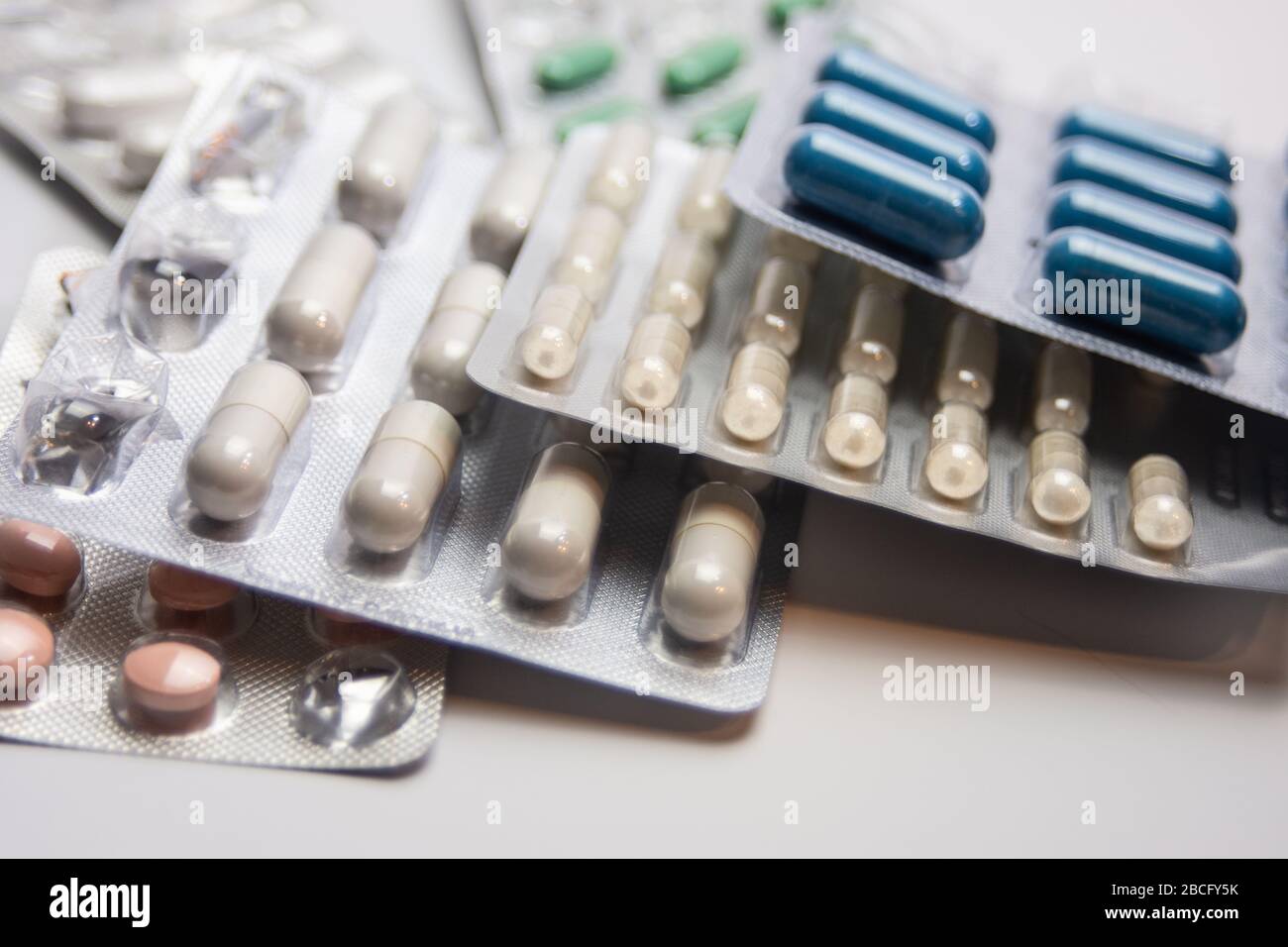 pill packs with colorful medicaments lying on the white background ...