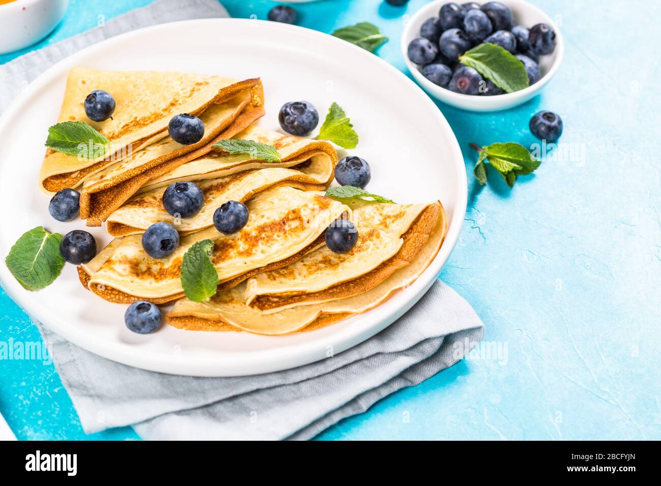 Crepes with blueberries at blue table Stock Photo - Alamy
