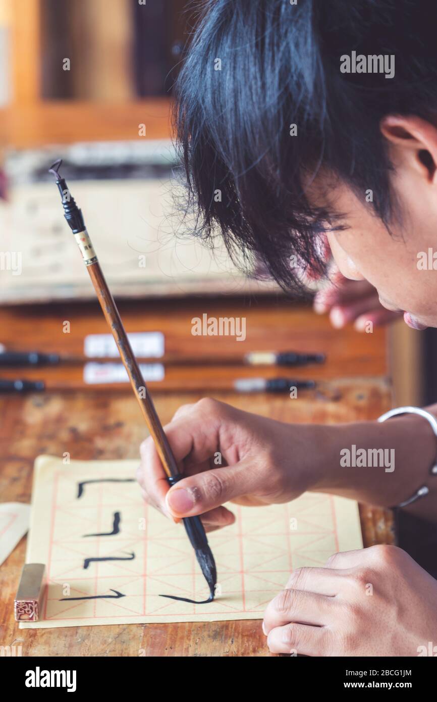 Yangshuo, China - August 2019 : Chinese student holding ink brush ...