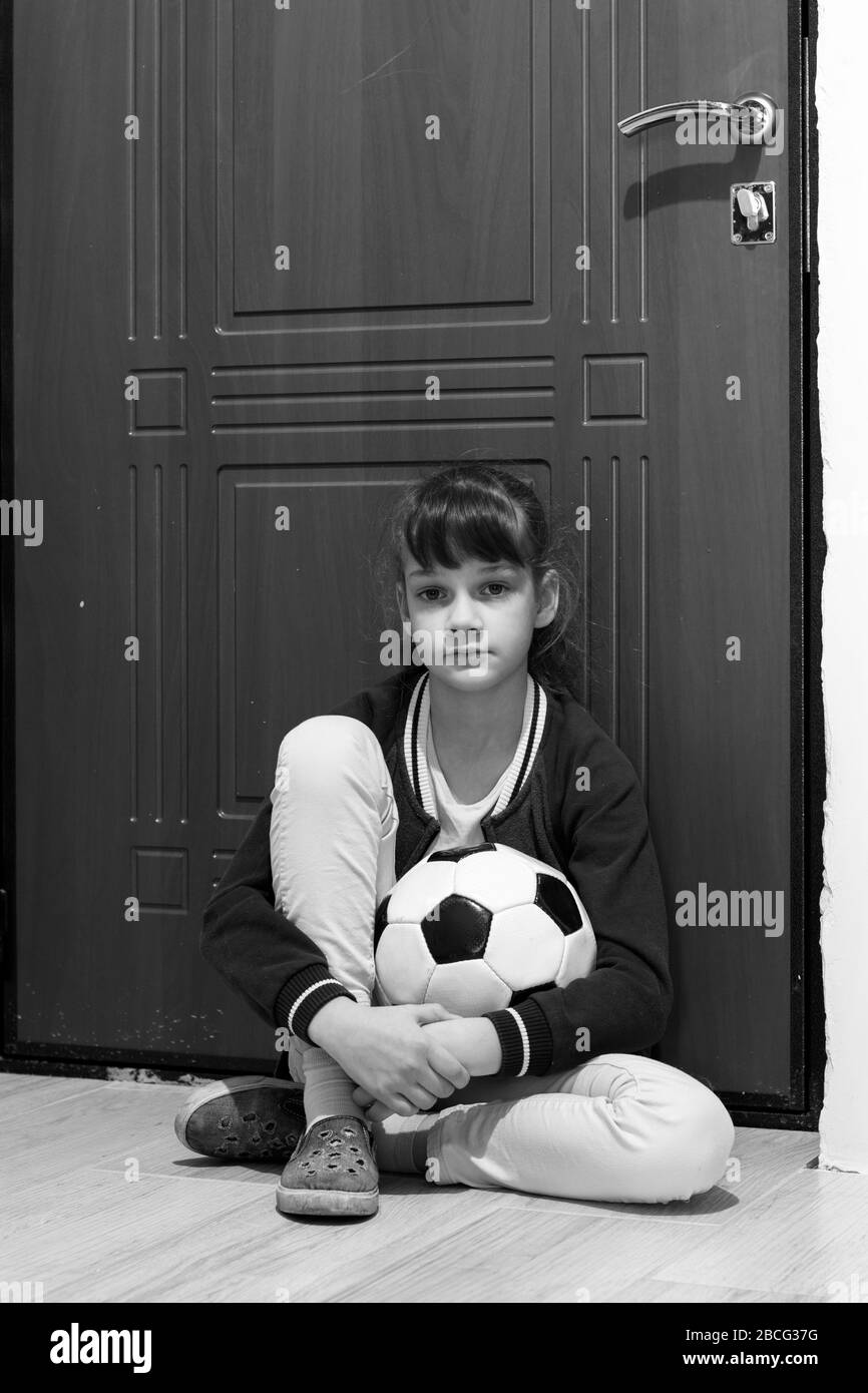 Girl locked up with a ball at the front door Stock Photo - Alamy